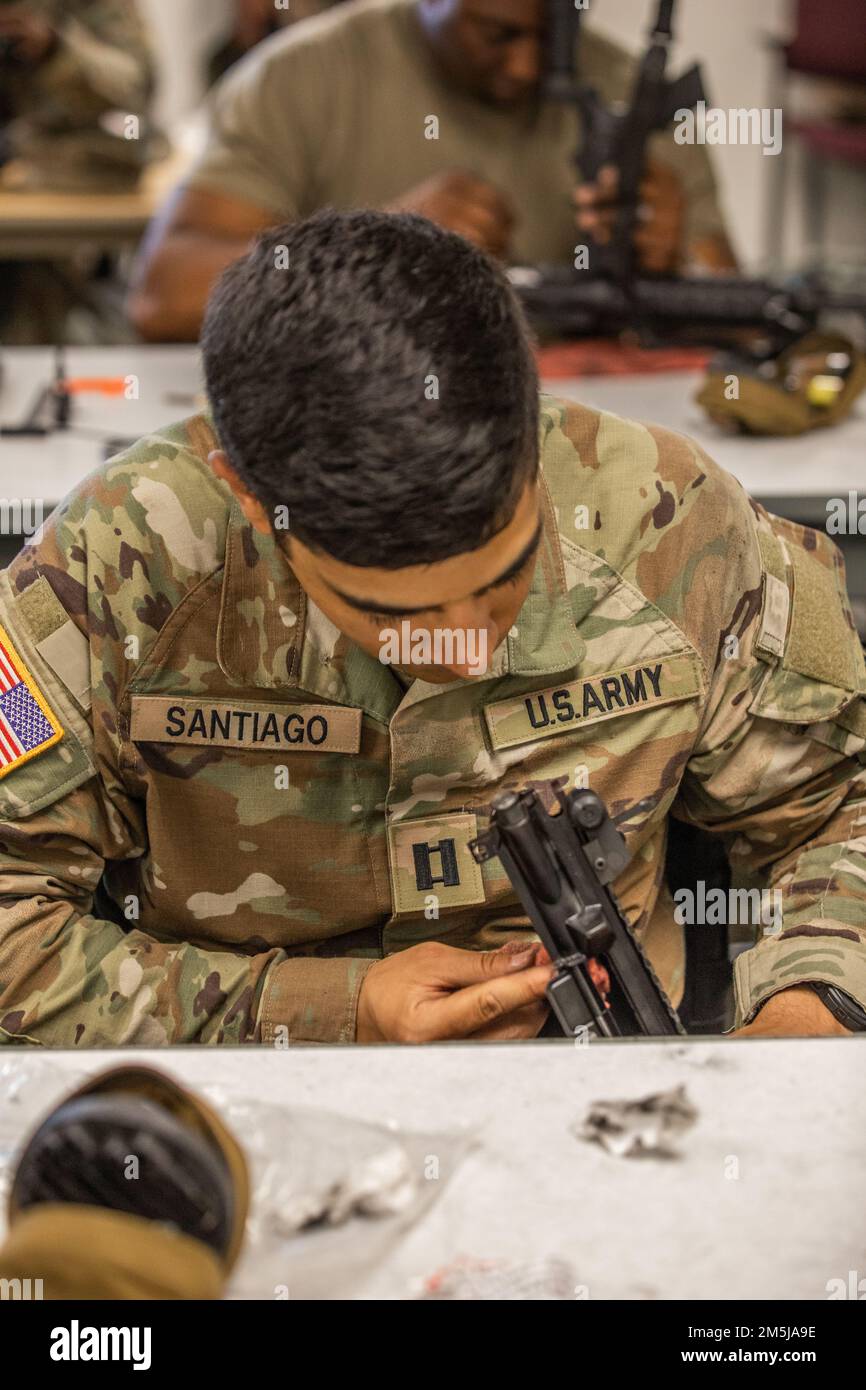 U.S. Army Cpt. Joshua Santiago, 335th Signal Command (Theater), conducts weapon maintenance ...