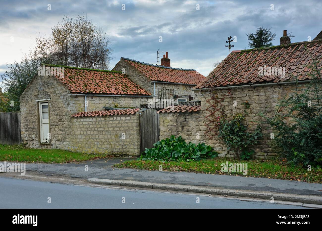 Traditional pantile roofing on house and outbuildings. Hovingham. North ...