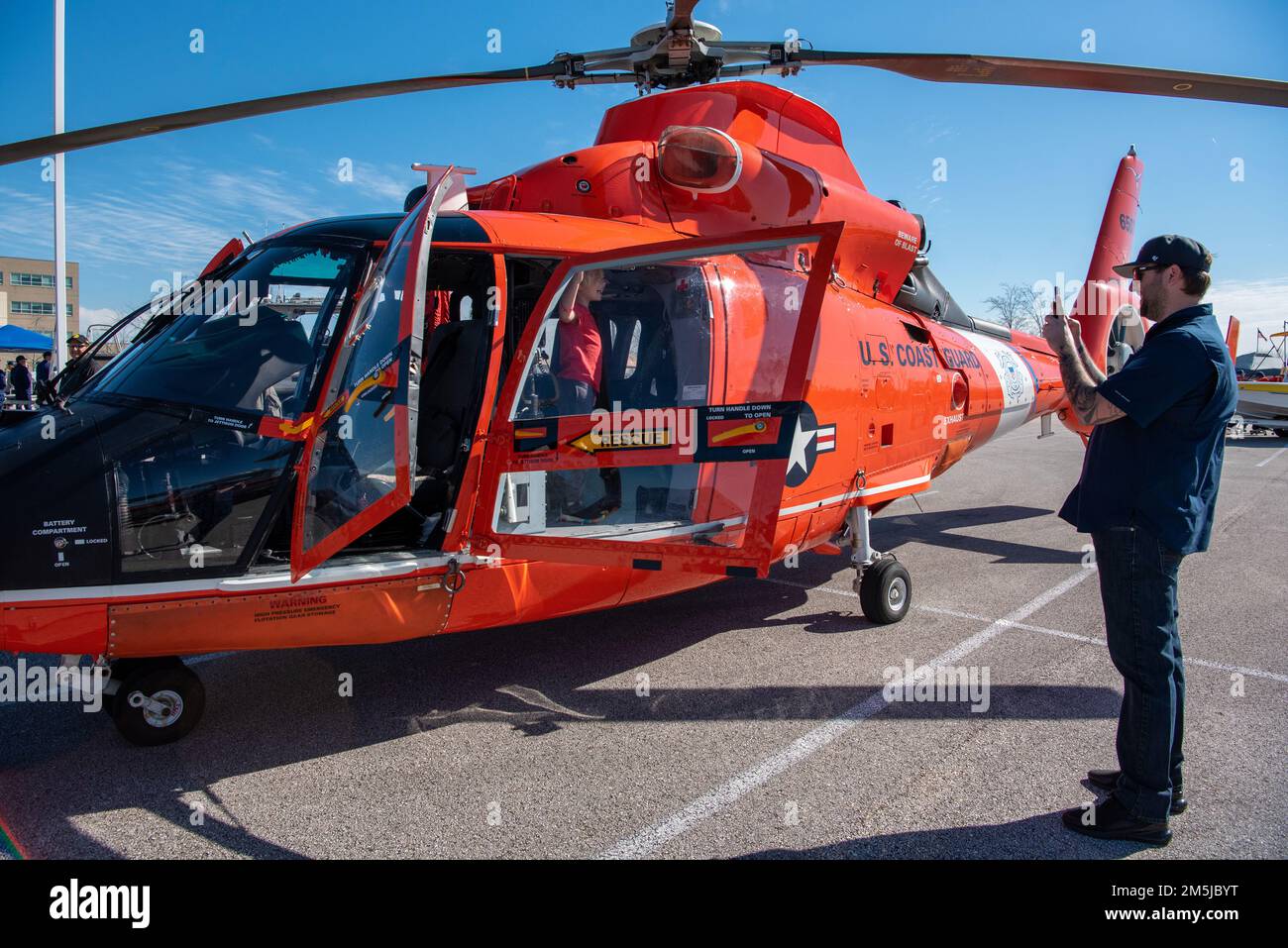 A member of the public takes a photo of a Coast Guard Air Station ...