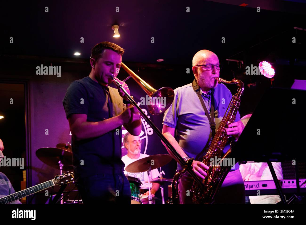 jazz musicians playing trombone and saxophone at a gig in West Malvern ...