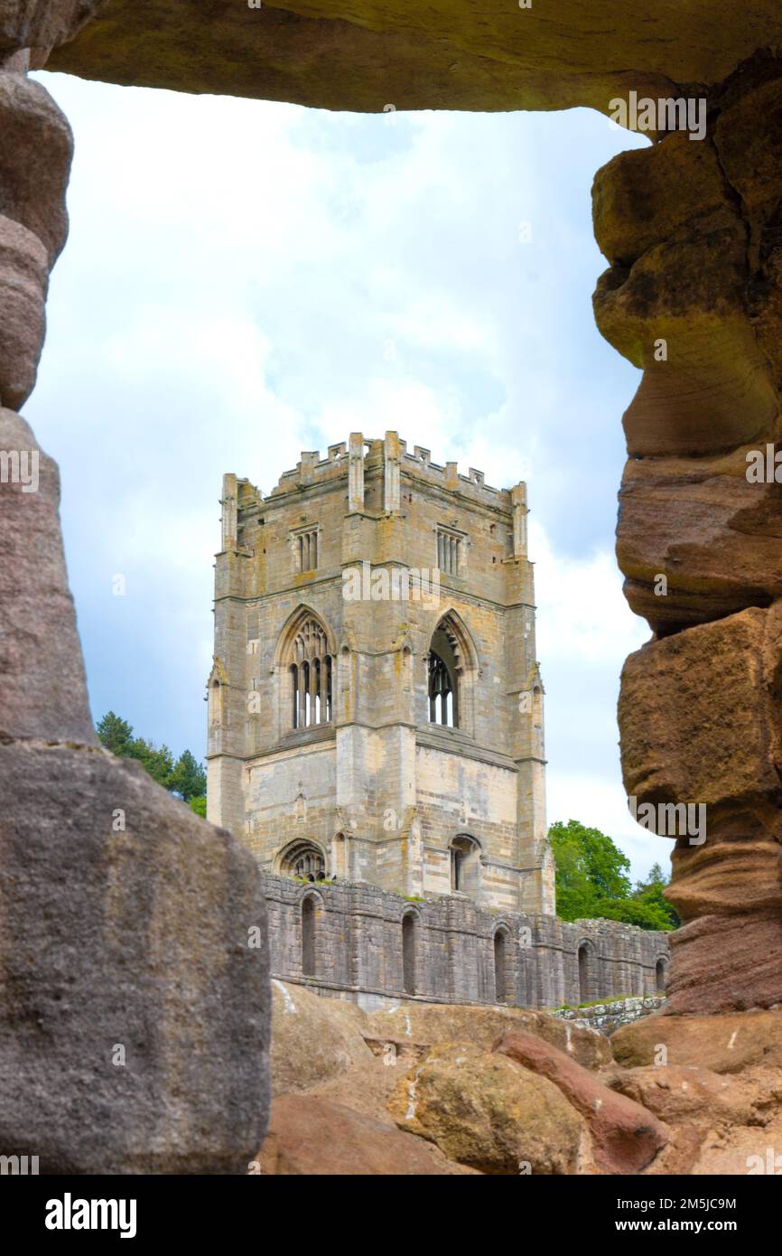Fountains abbey and church through a stone arch near ripon yorkshire uk ...