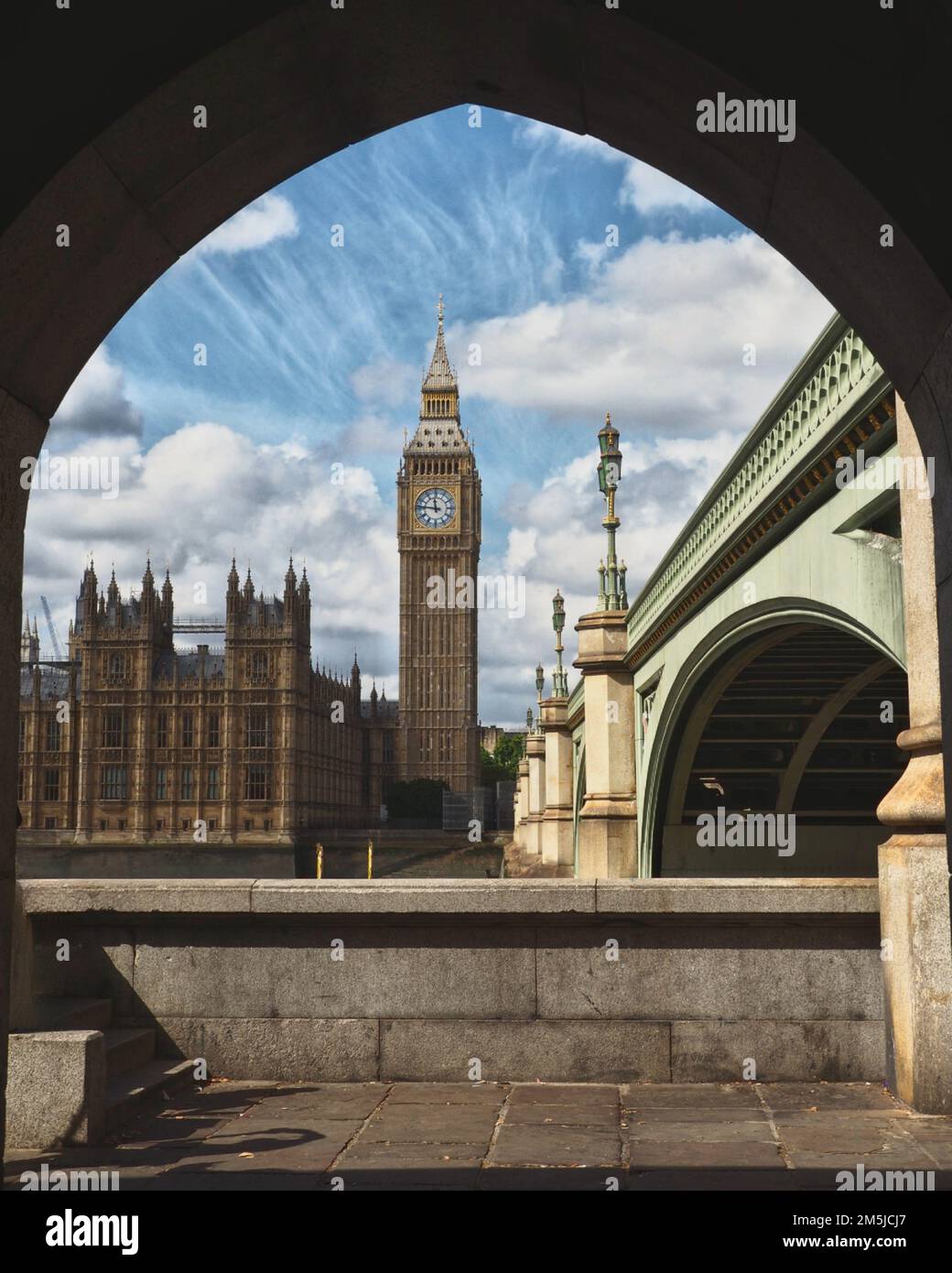 A vertical view of the Big Ben seen through arch in London, England ...