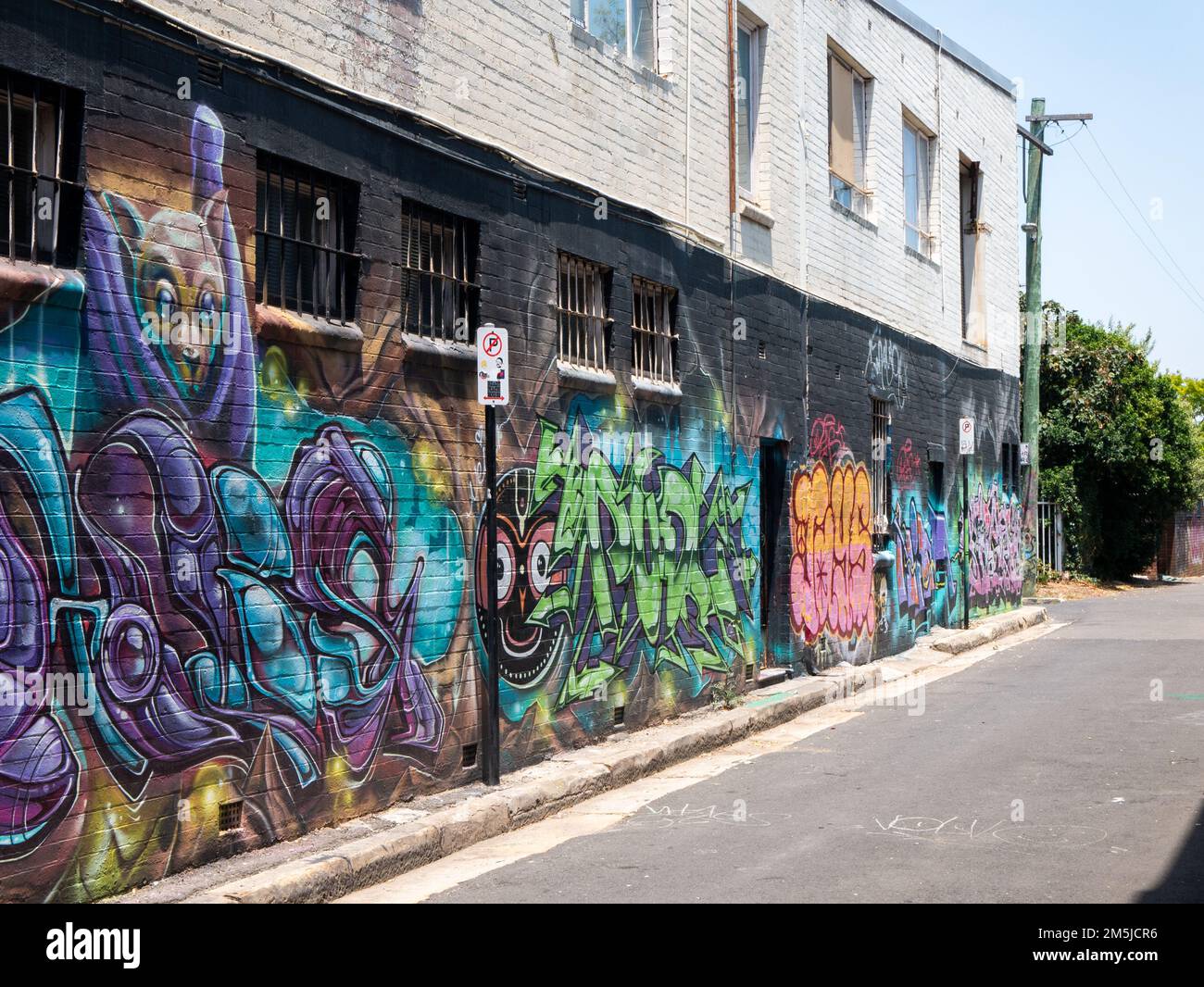 A daytime view of colorful graffiti art on the walls in Sydney ...