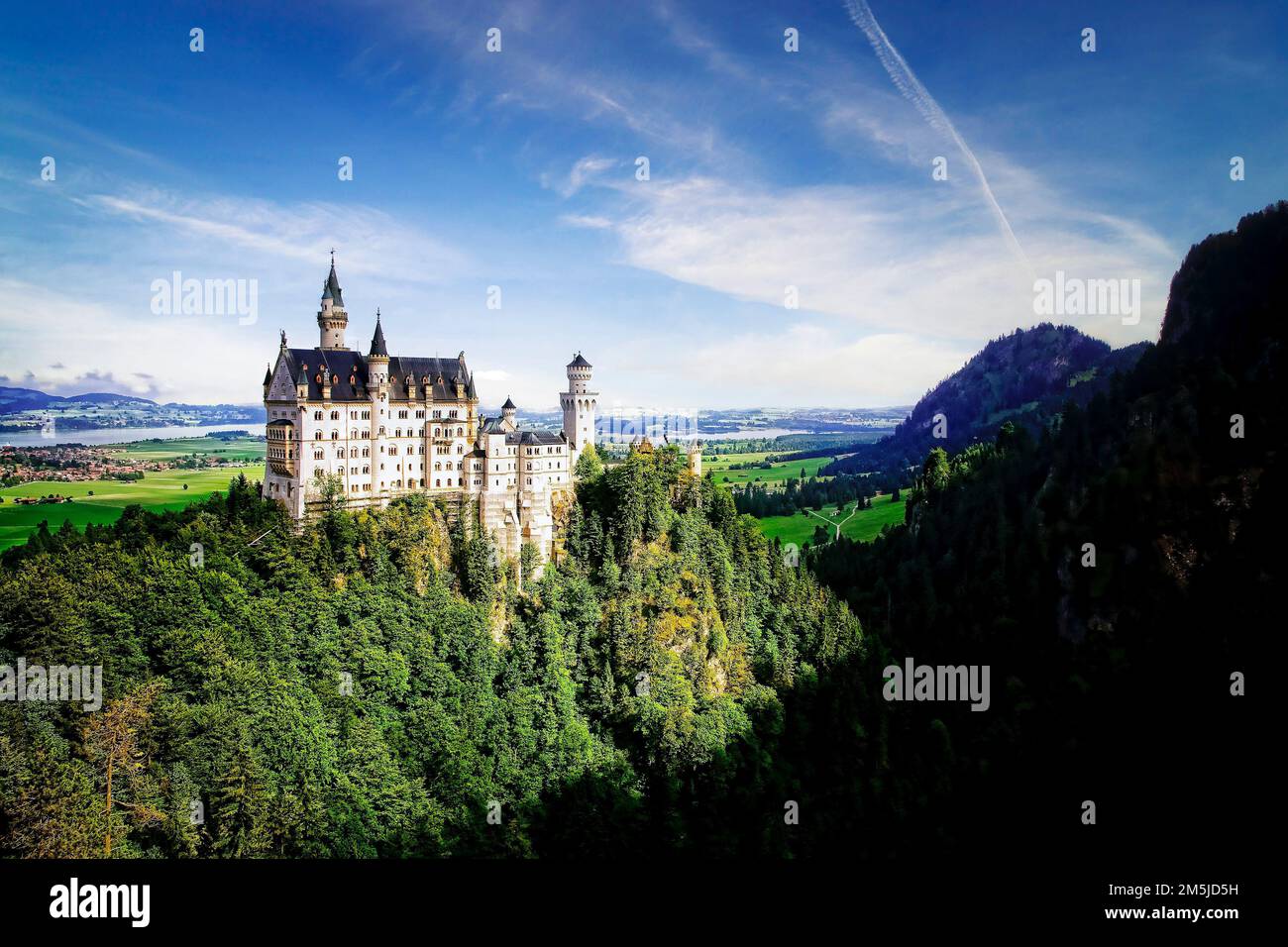 Neuschwanstein Castle lords above a fertile valley in the foothills of ...