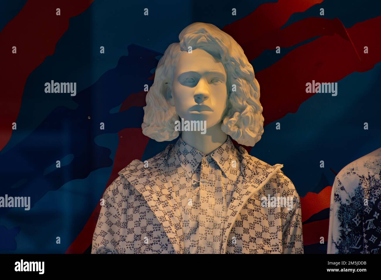 A Boy Mannequin with Long Hair on Red and Blue Background Stock Photo ...