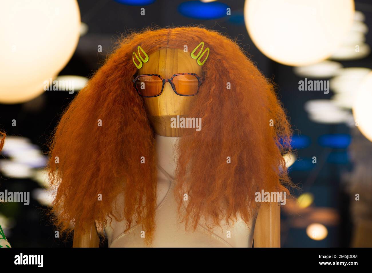 A wooden Doll Mannequin with Red Hair and Sunglasses Stock Photo - Alamy