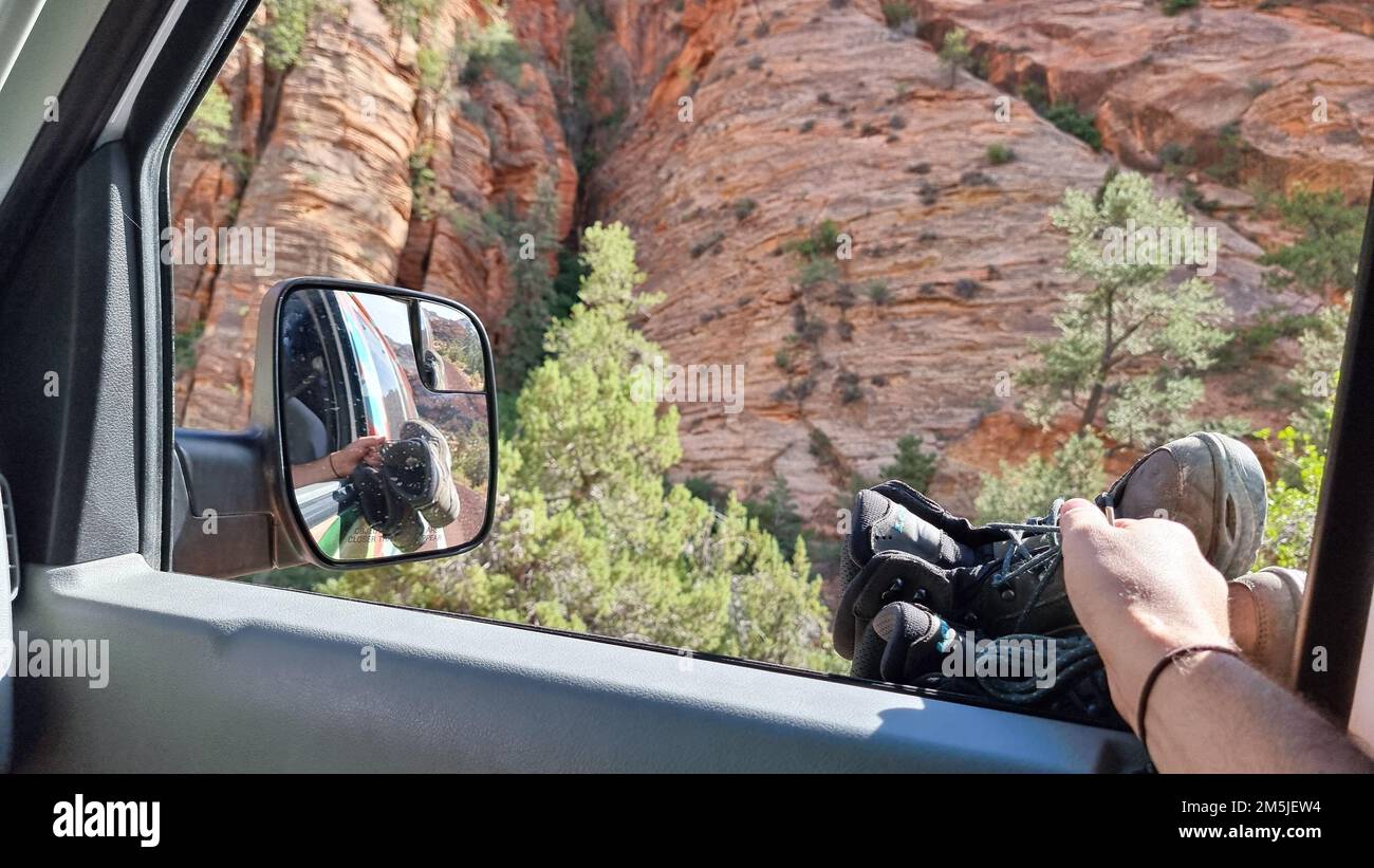 drying trekking boots from car window while driving Stock Photo - Alamy