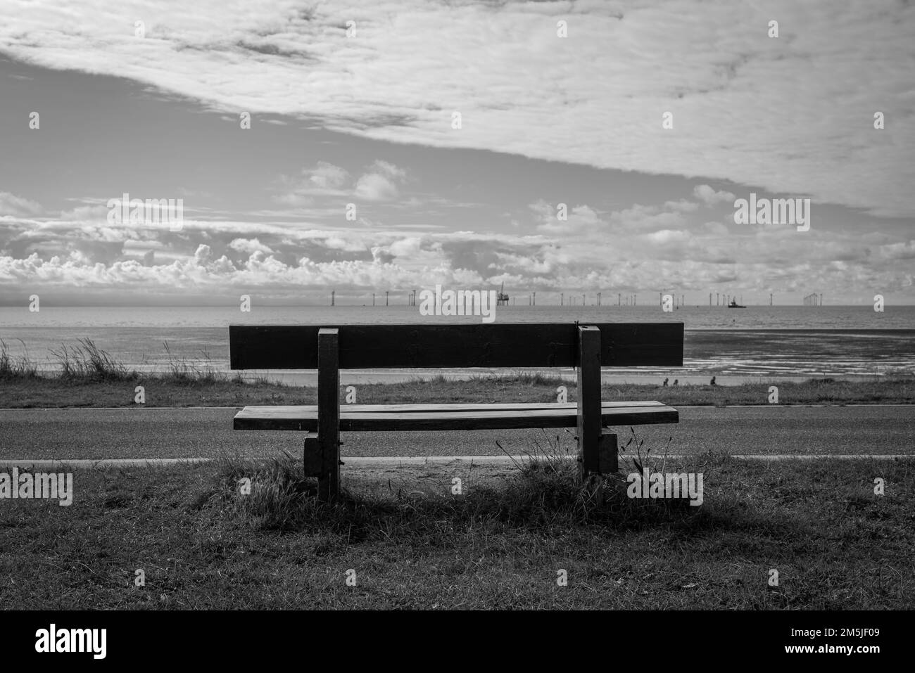 an empty bench at Crosby beach Stock Photo - Alamy