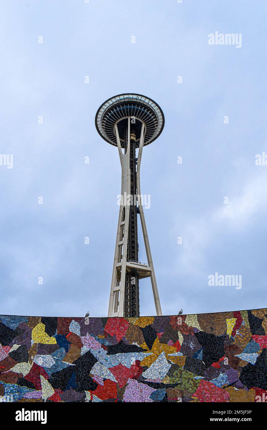 A vertical low angle shot of Space Needle behind a colorful mural in ...