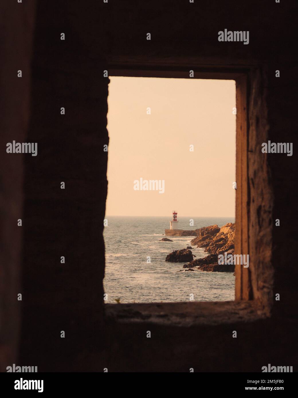 The lighthouse from the window of an old fortress, vertical Stock Photo ...