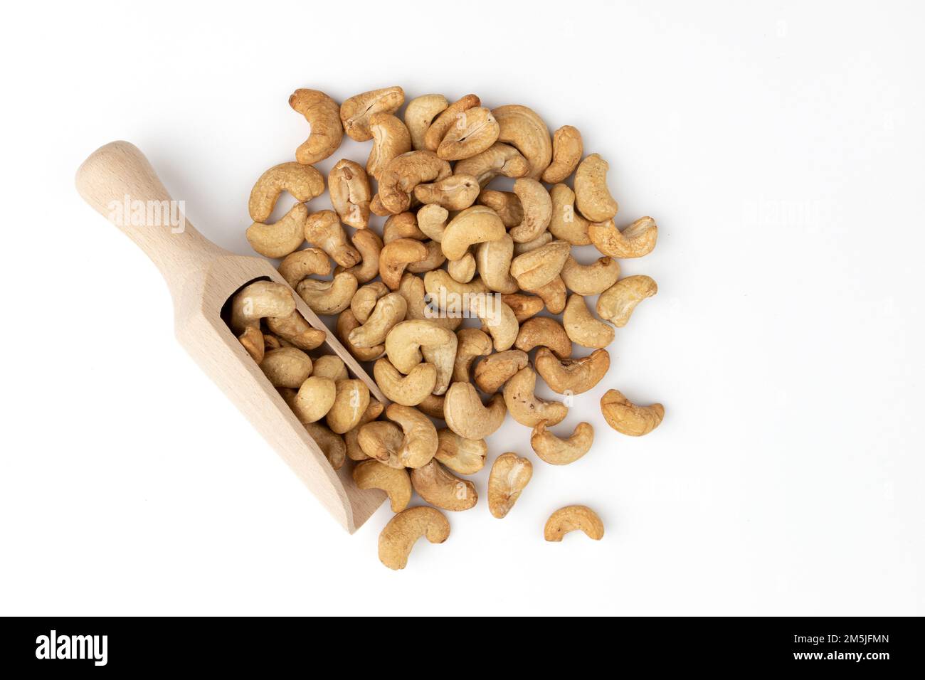 roasted cashew nuts and scoop isolated on white background, top view ...