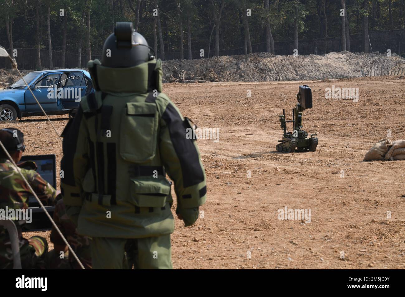 Bangladeshi Explosive Ordnance Disposal (EOD) Technician watches a ...