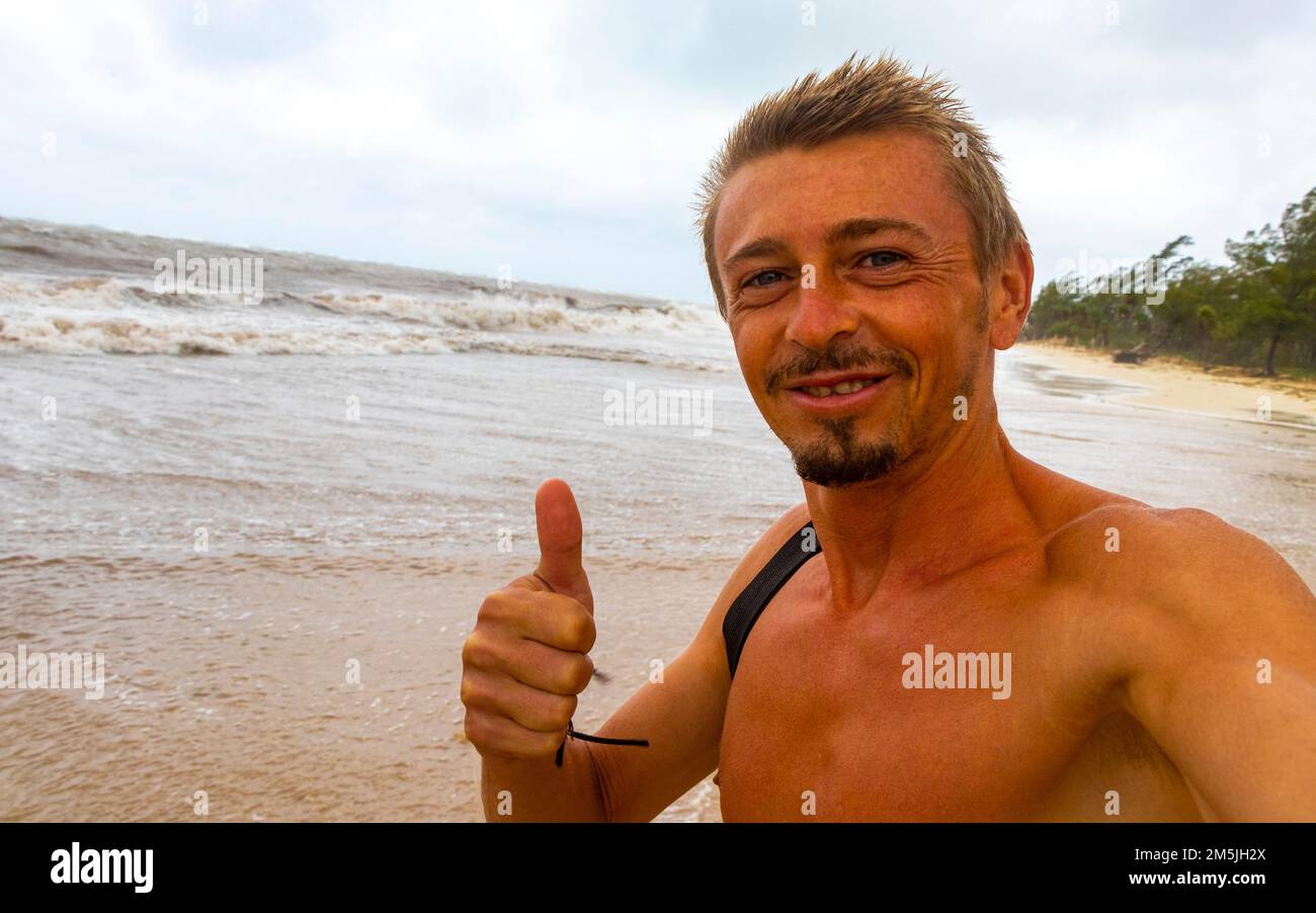 Man is out on the beach during the hurricane and enjoys in Playa del ...
