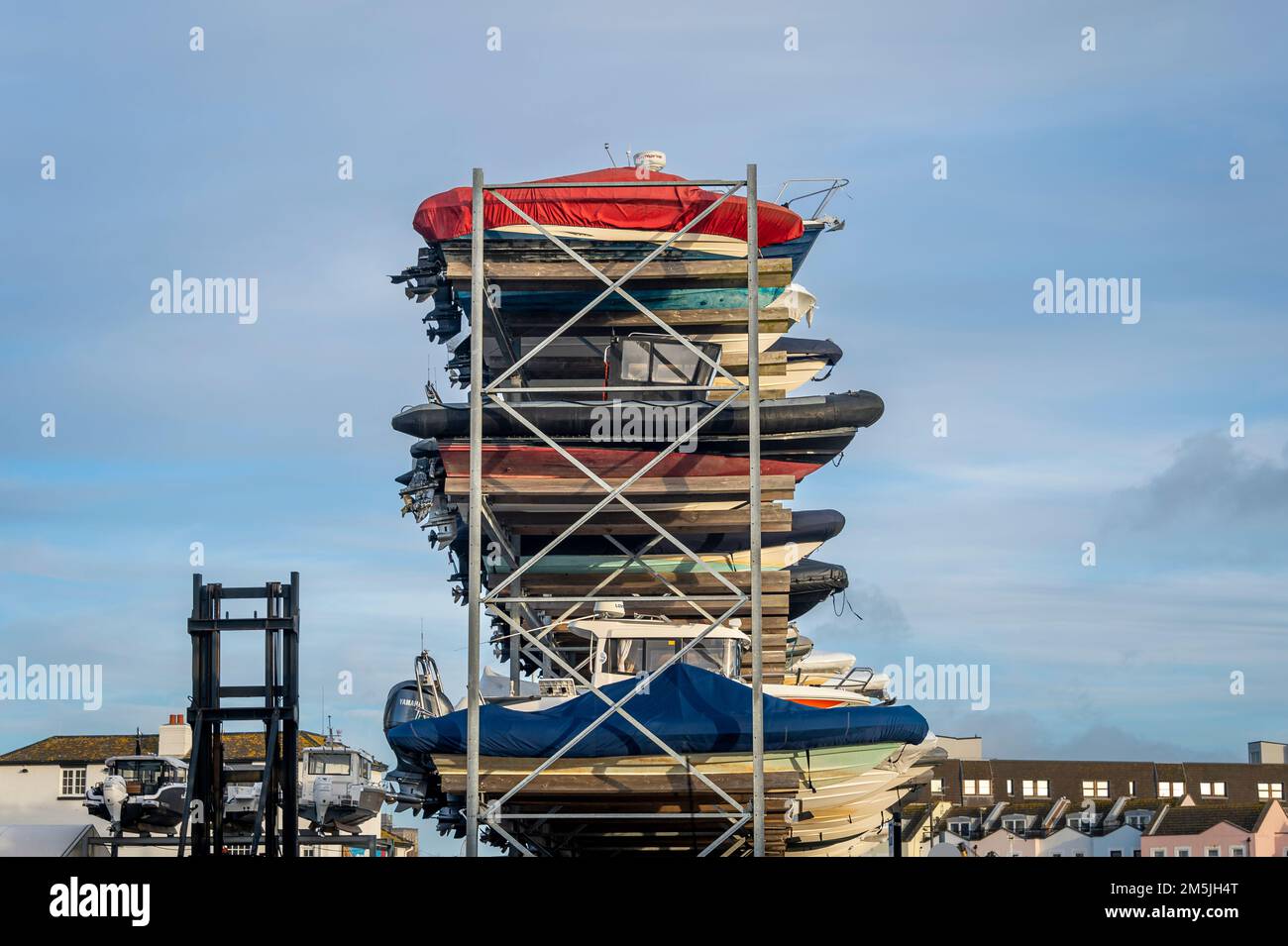 motorboats racked one above another on two levels in a dry rack boat ...