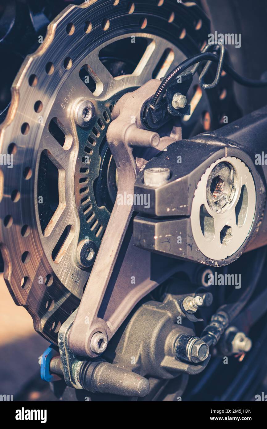 A vertical detailed view of a motorcycle rear break under the sunlight ...