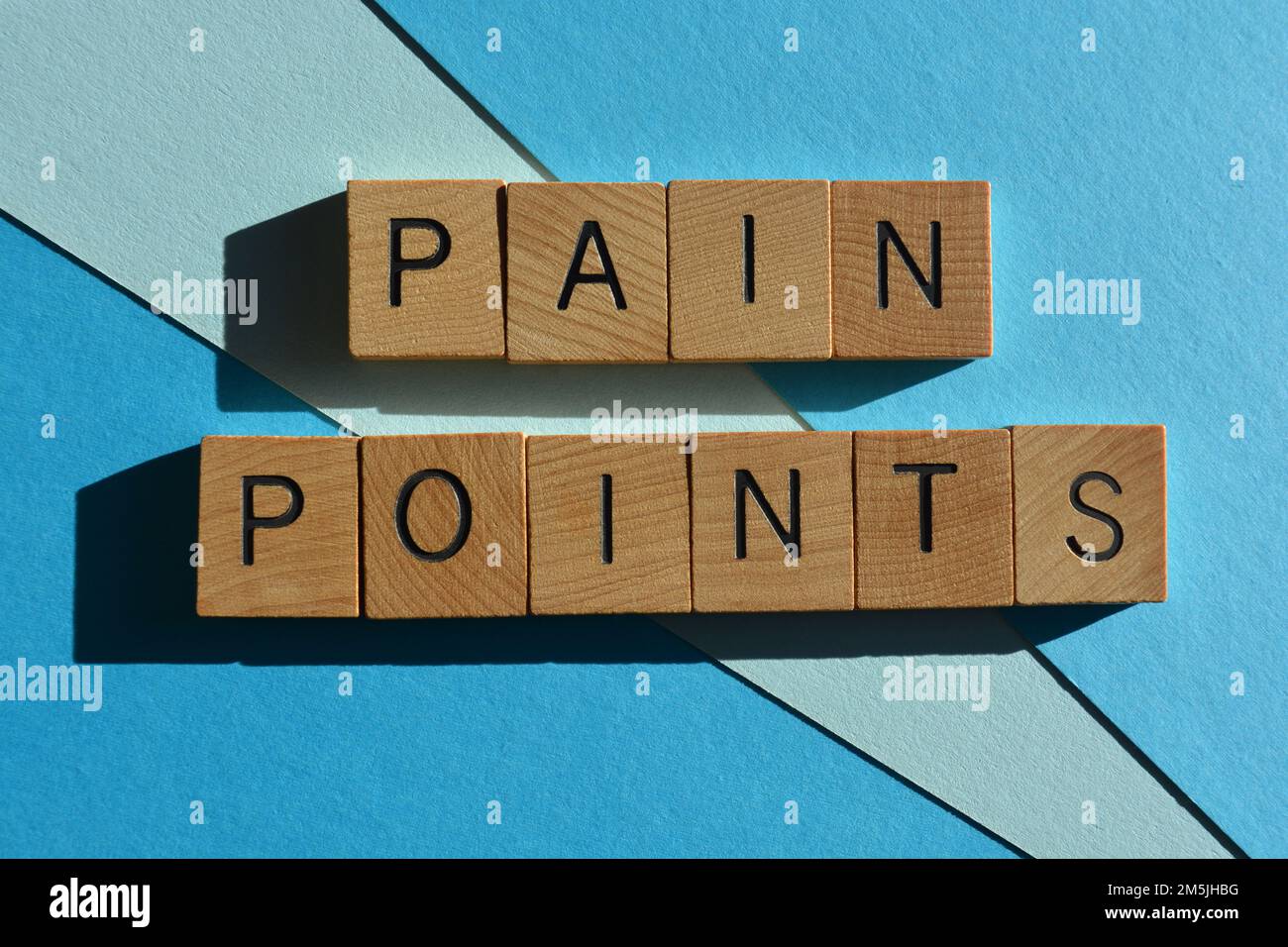 Pain Points, words in wooden alphabet letters isolated on blue ...