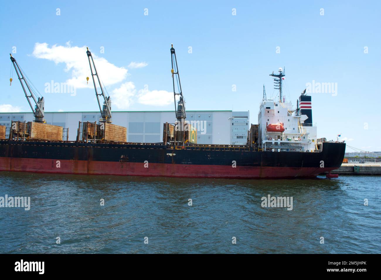 Container freight ship at dock in port Stock Photo - Alamy
