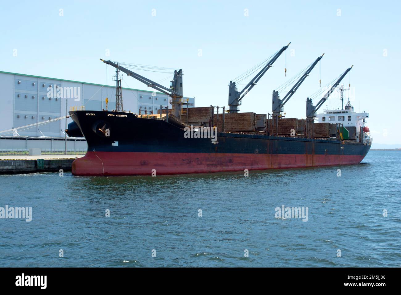 Container freight ship at dock in port Stock Photo - Alamy