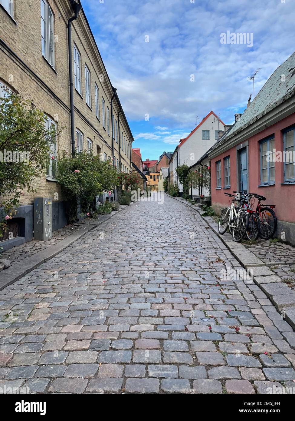 Around the narrow streets of Lund are traditional houses, bikes, and ...