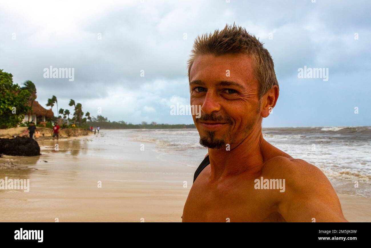 Man is out on the beach during the hurricane and enjoys in Playa del ...