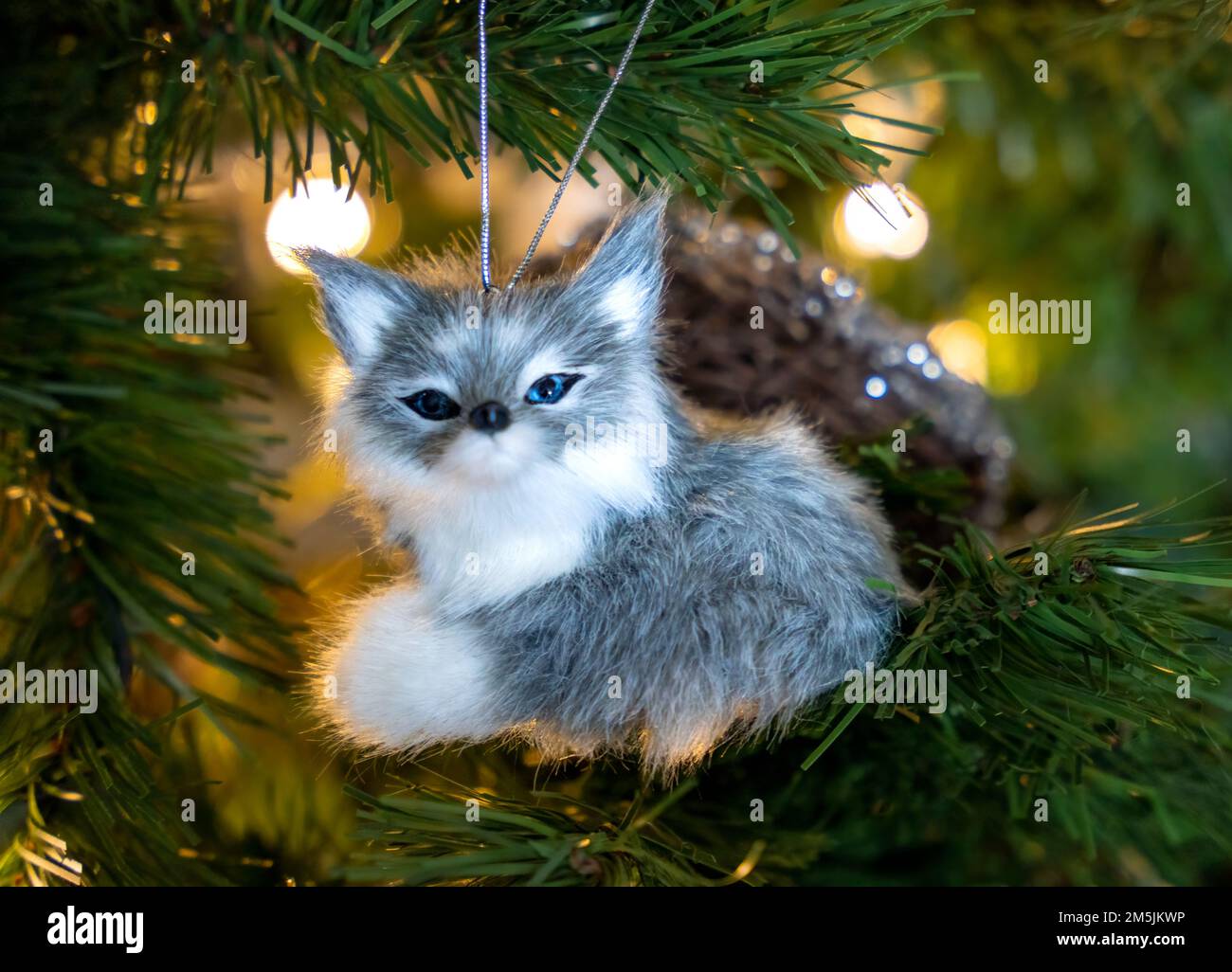 Silver fox Christmas ornament hanging in an artificial Christmas tree ...