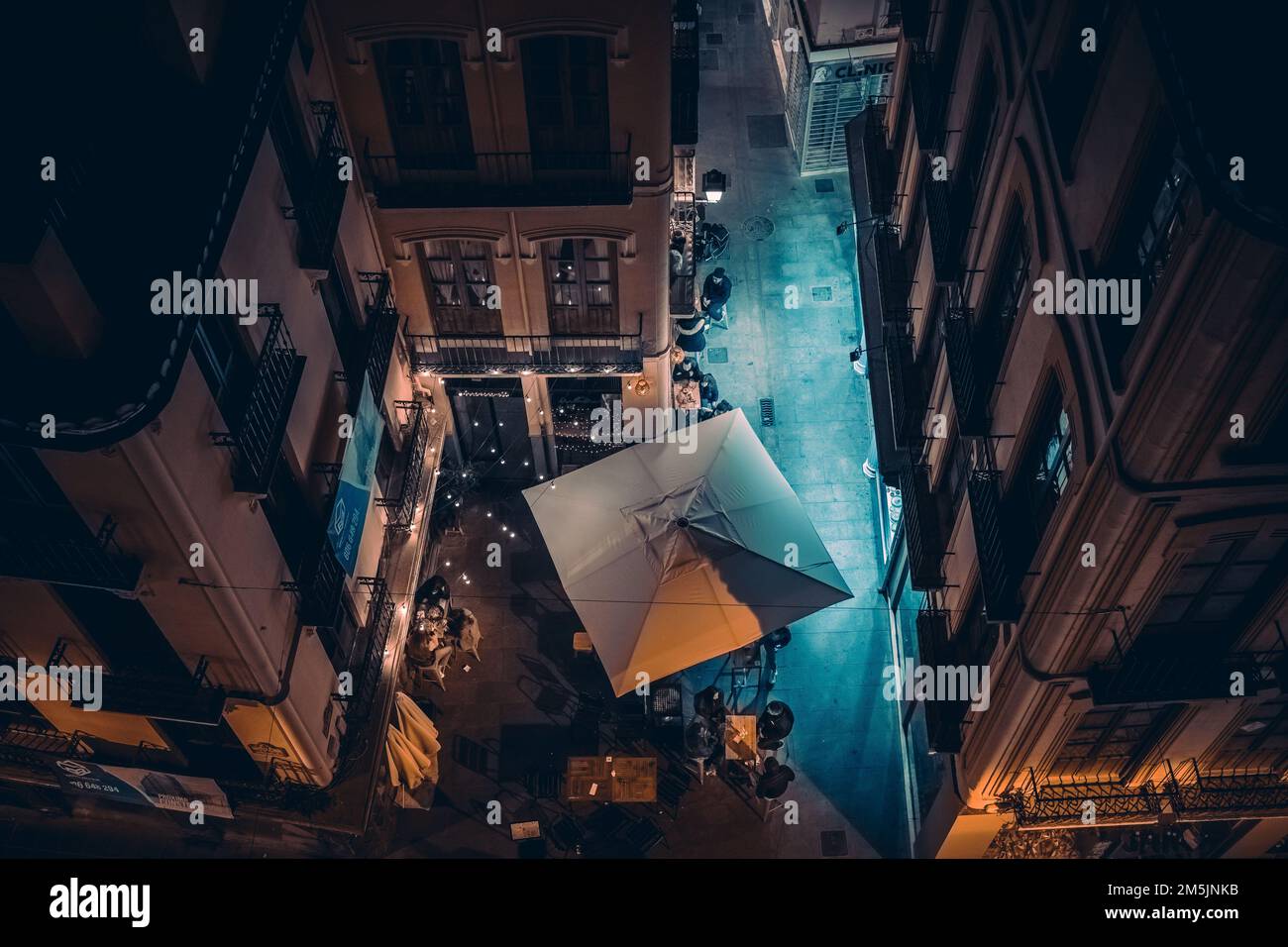 An aerial shot of city life with people enjoying their evening in a ...