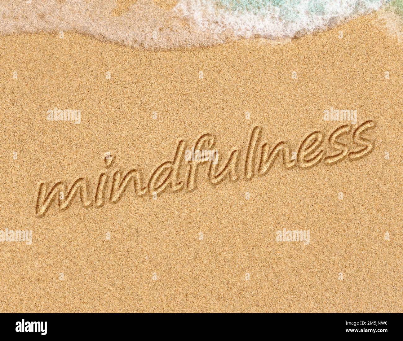 mindfulness concept, mindful living, text written on the sand of beach ...