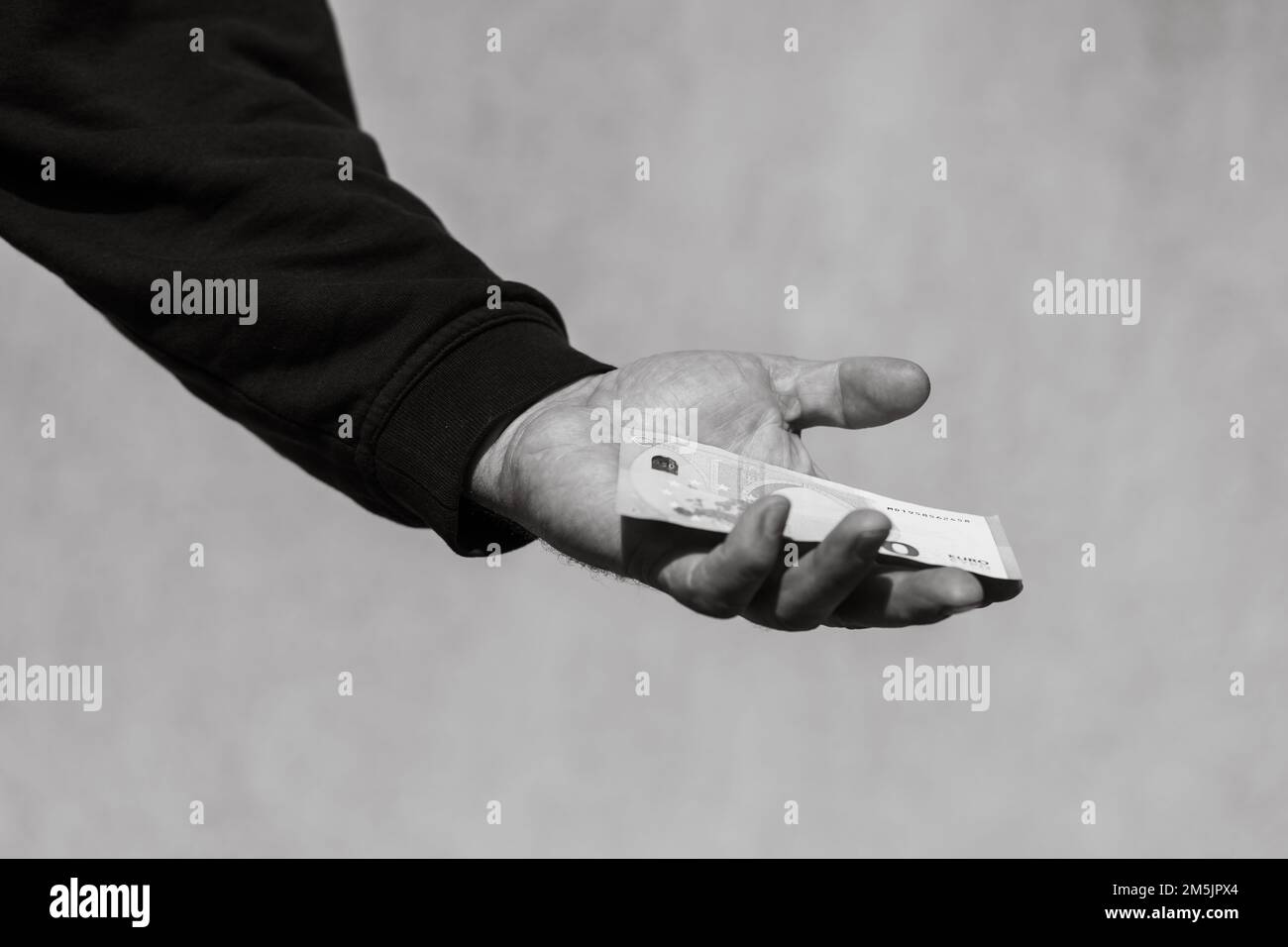 Hand giving money like bribe or tips or salary isolated, hard worked ...