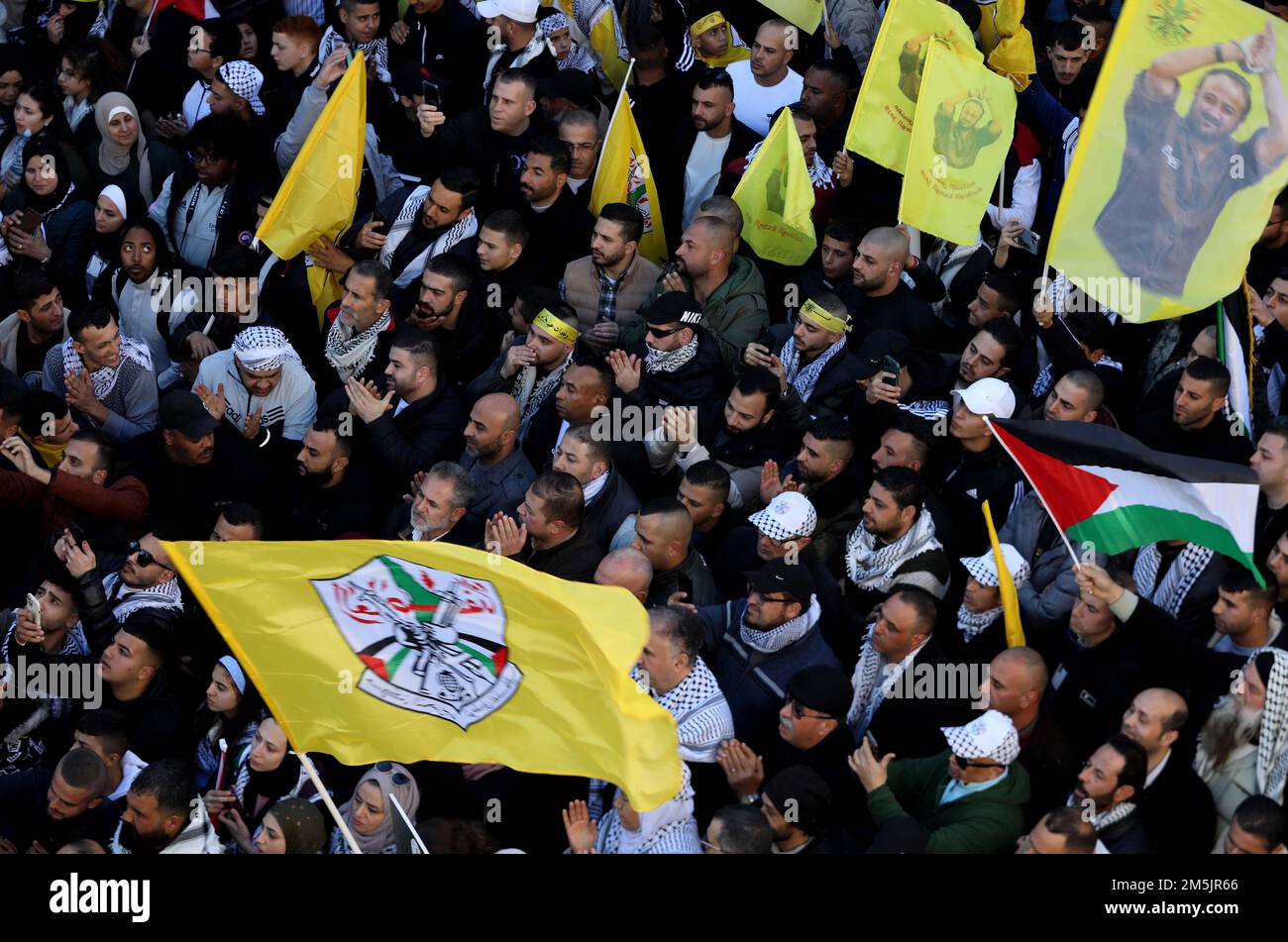 Ramallah. 29th Dec, 2022. People take part in a rally marking the 58th ...
