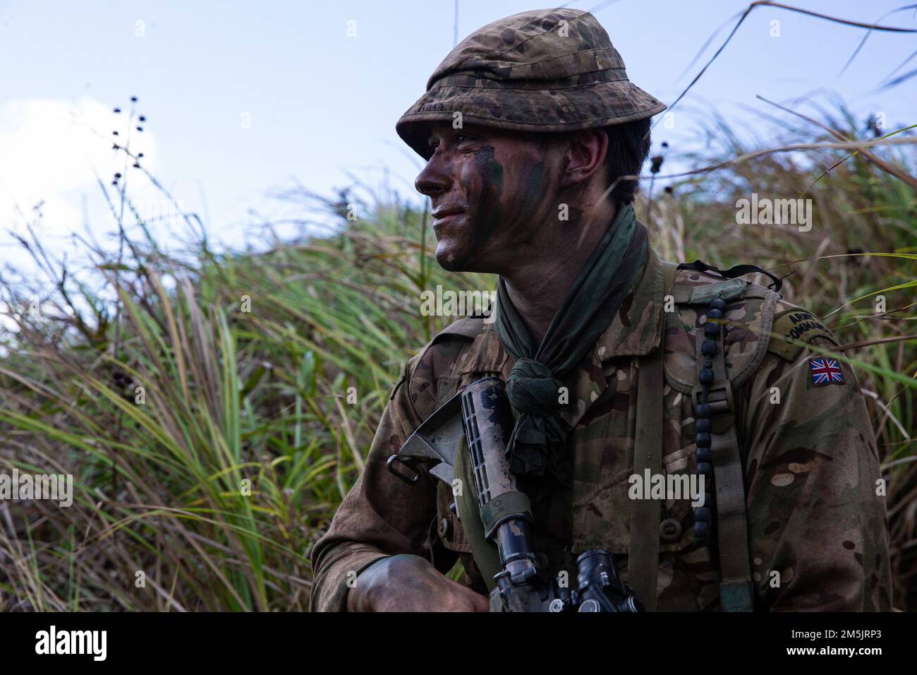A British Army Commando with 40 Commando Royal Marines, observes the ...