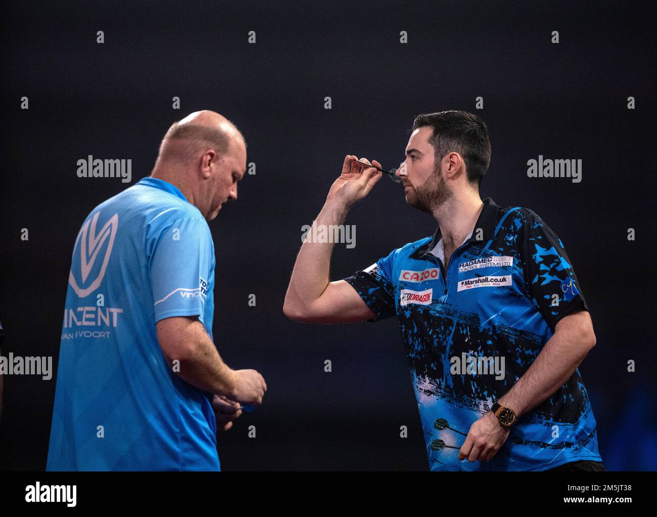 Luke Humphries (right) and Vincent van der Voort in action during day ...