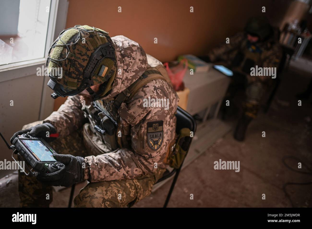 A Ukrainian servicemember operates a surveillance drone with a handheld ...