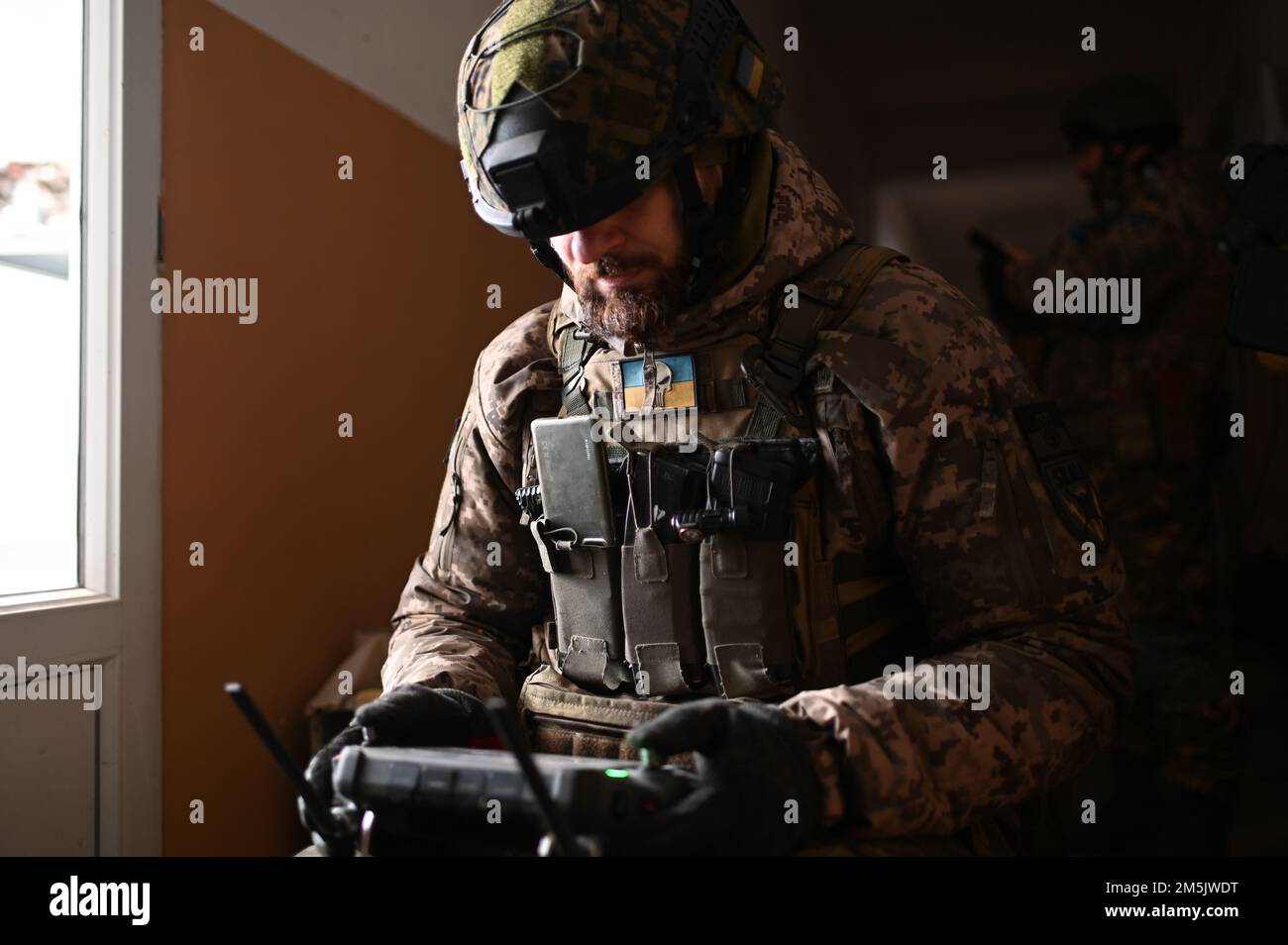 A Ukrainian servicemember operates a surveillance drone with a handheld ...