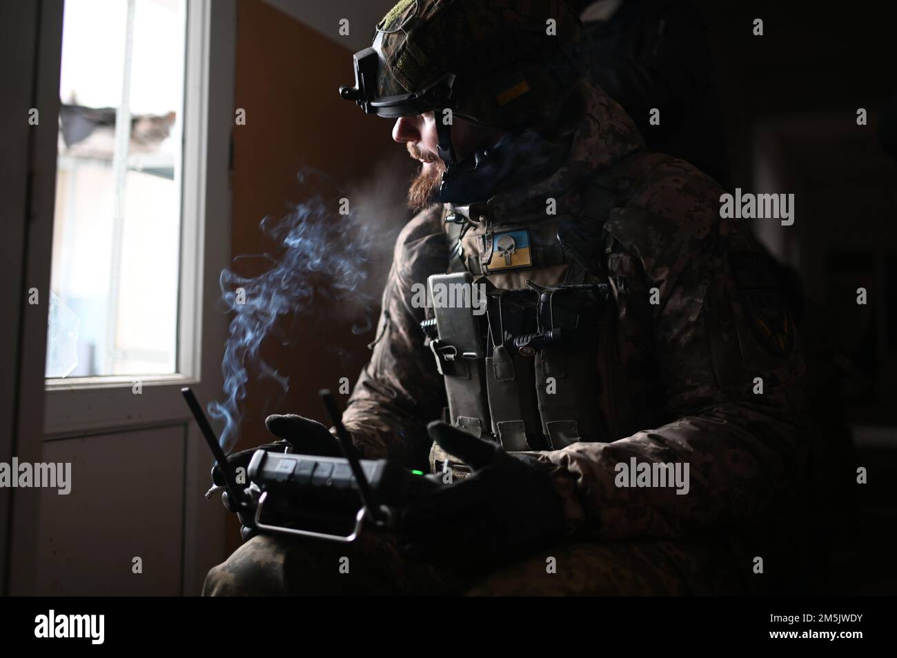 A Ukrainian servicemember operates a surveillance drone with a handheld ...