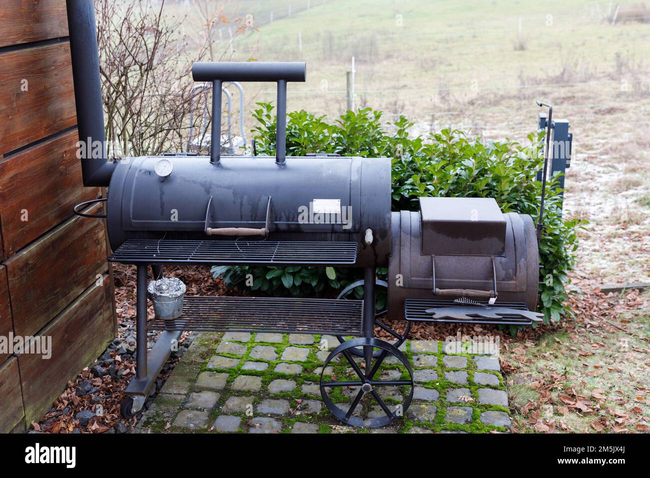 The barbecue grill is in the middle of the yard on the lawn. Cooking in ...