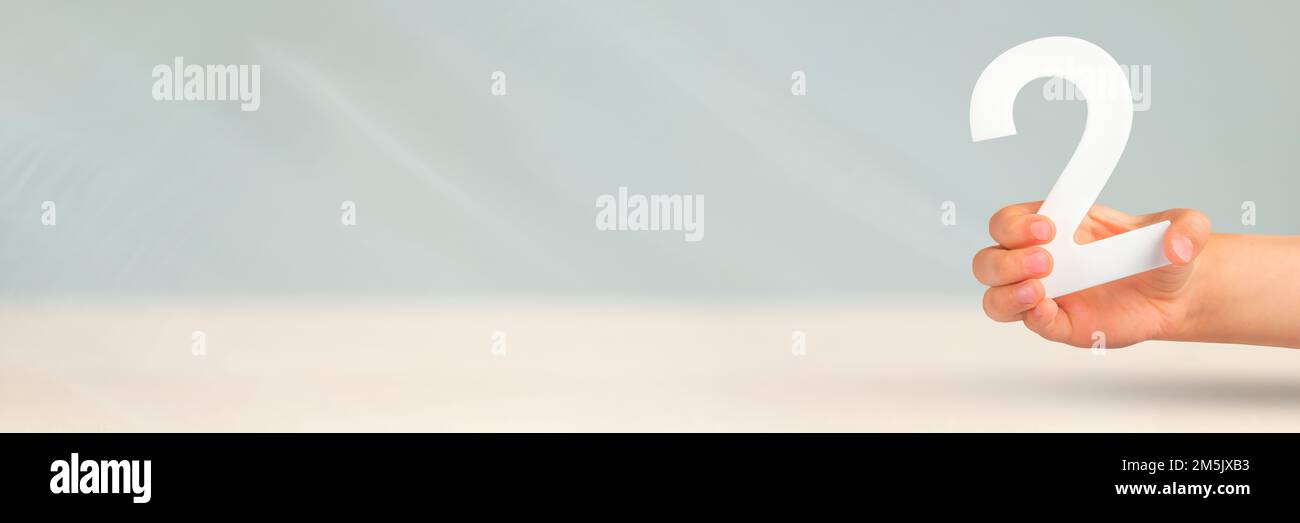 Number two in hand. Hand holding white number 2 on blurred background ...