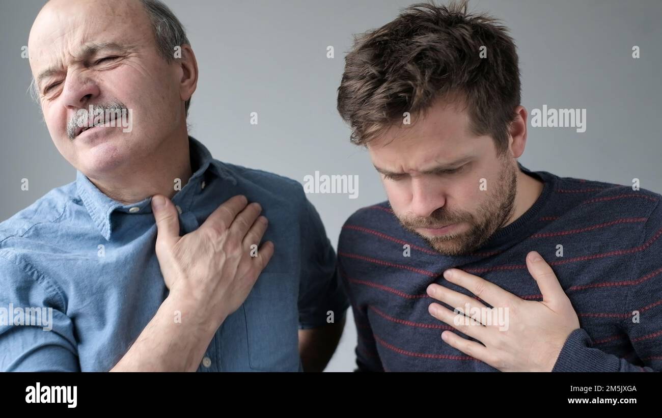 Two men father and son feeling unwell and coughing as symptom for cold ...