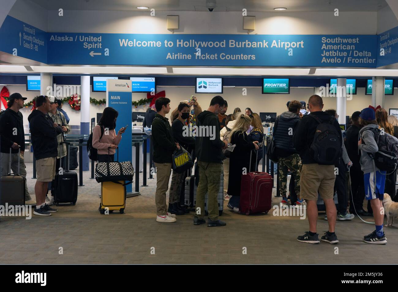 Passengers wait in line to check in luggage at the Southwest, Frontier ...