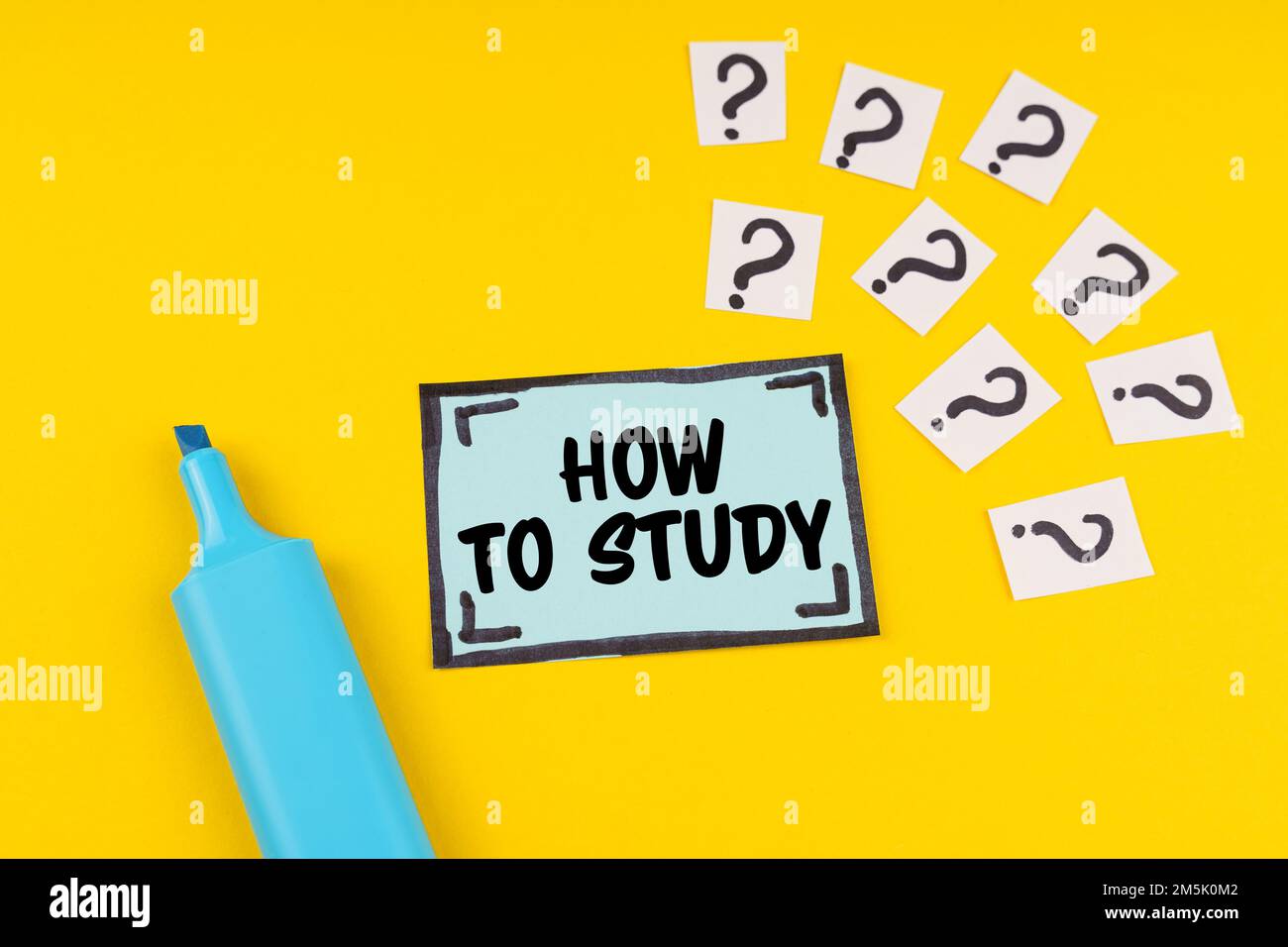 Education concept. On the yellow surface lies a blue marker, question ...