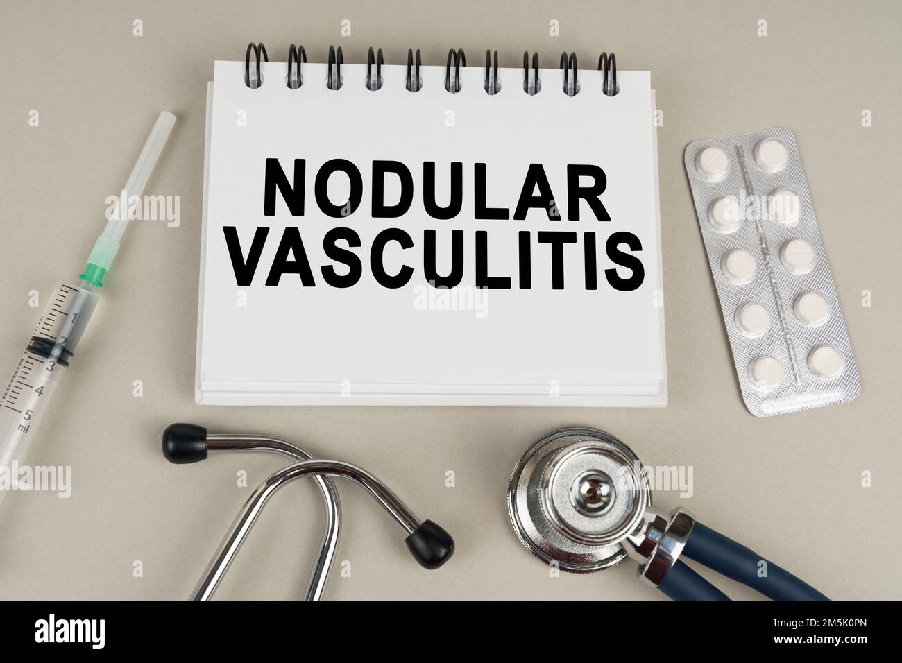 Medical concept. On a gray surface, a syringe, a thermometer, a ...