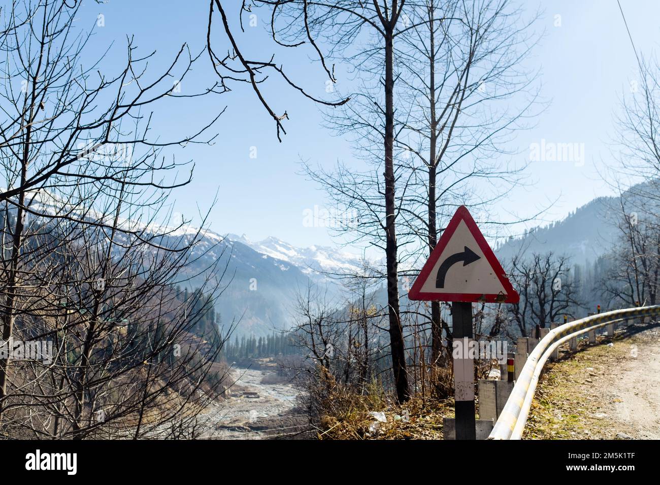 Road sign warning against slippery road due to snow ice Stock Photo - Alamy