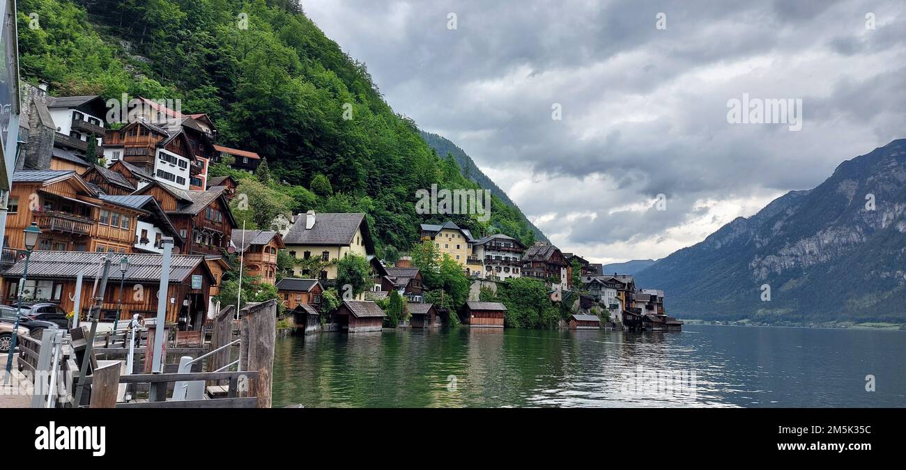 A beautiful view of small houses on a shore with green trees on a ...
