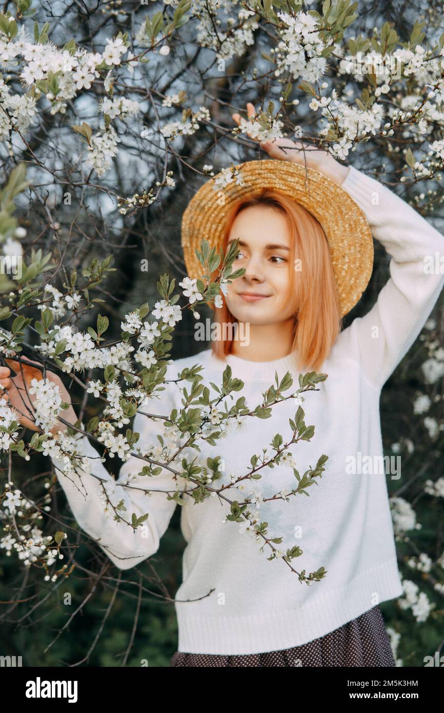 Portrait of a woman in a straw hat in a cherry blossom. Free outdoor ...