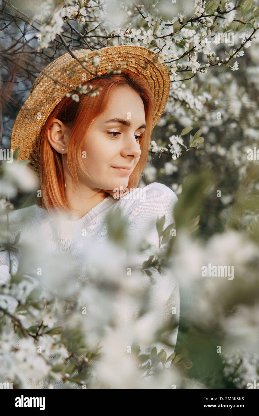 Portrait of a woman in a straw hat in a cherry blossom. Free outdoor ...