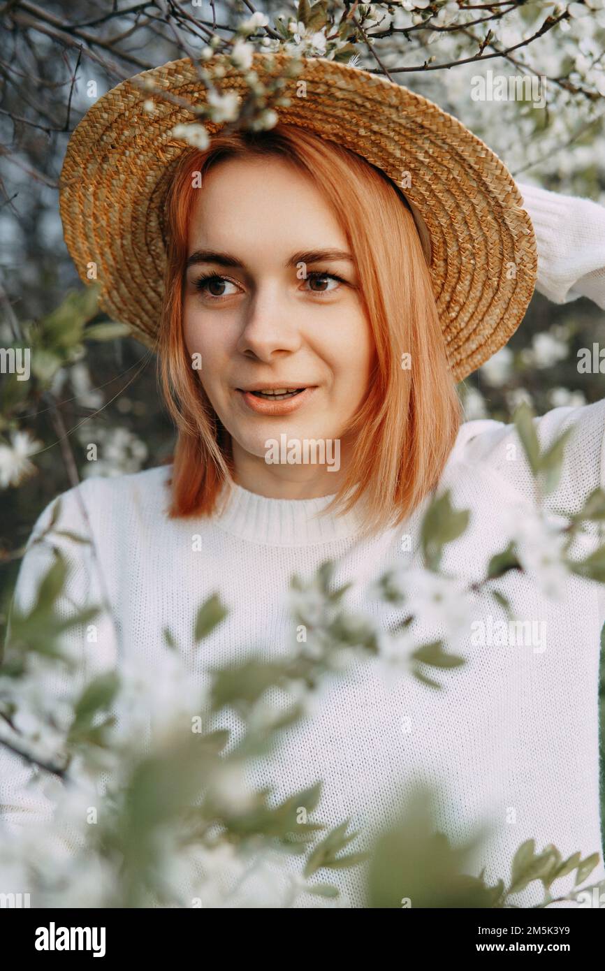 Portrait of a woman in a straw hat in a cherry blossom. Free outdoor ...