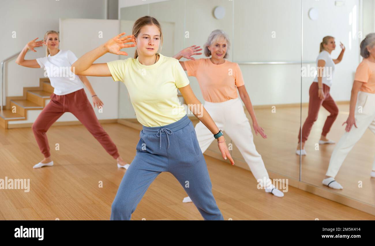 Young girl performing aerobic dance during group training Stock Photo ...