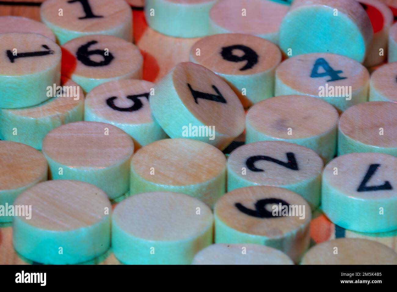 A pile of wooden round tokens with numbers Stock Photo - Alamy