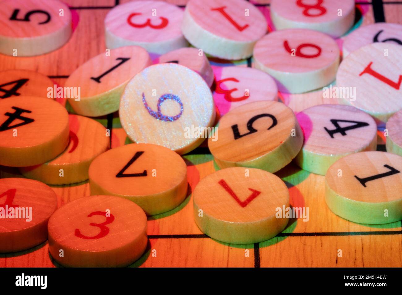 A pile of wooden round tokens with numbers Stock Photo - Alamy