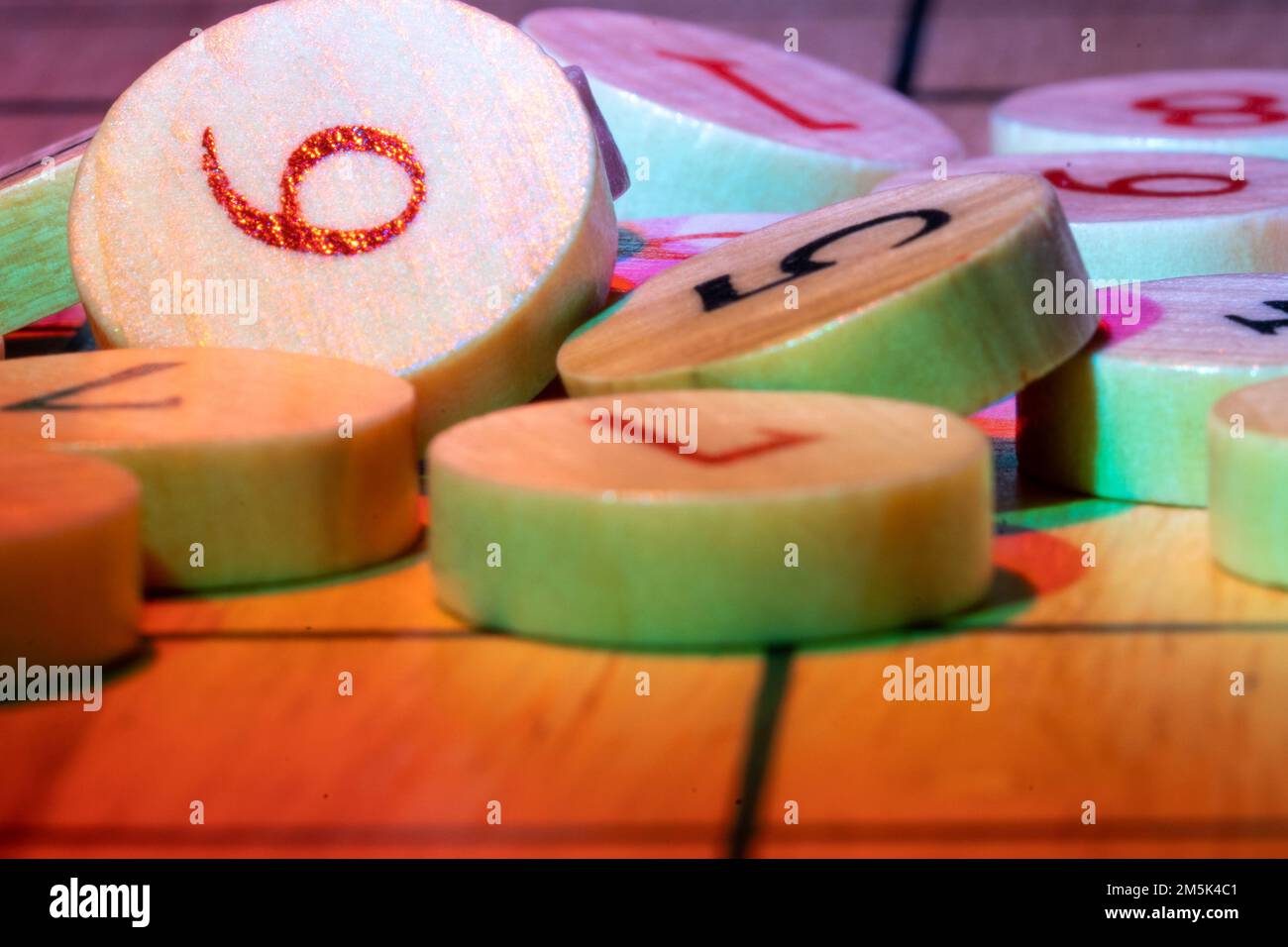 A pile of wooden round tokens with numbers Stock Photo - Alamy
