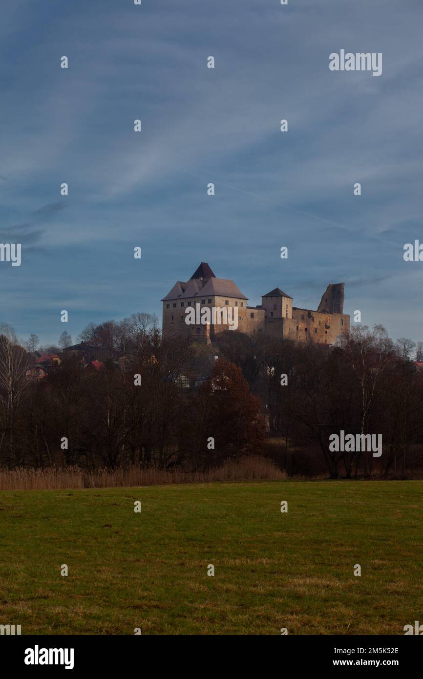 A medieval castle on its mound in the distance in good weather. In the ...
